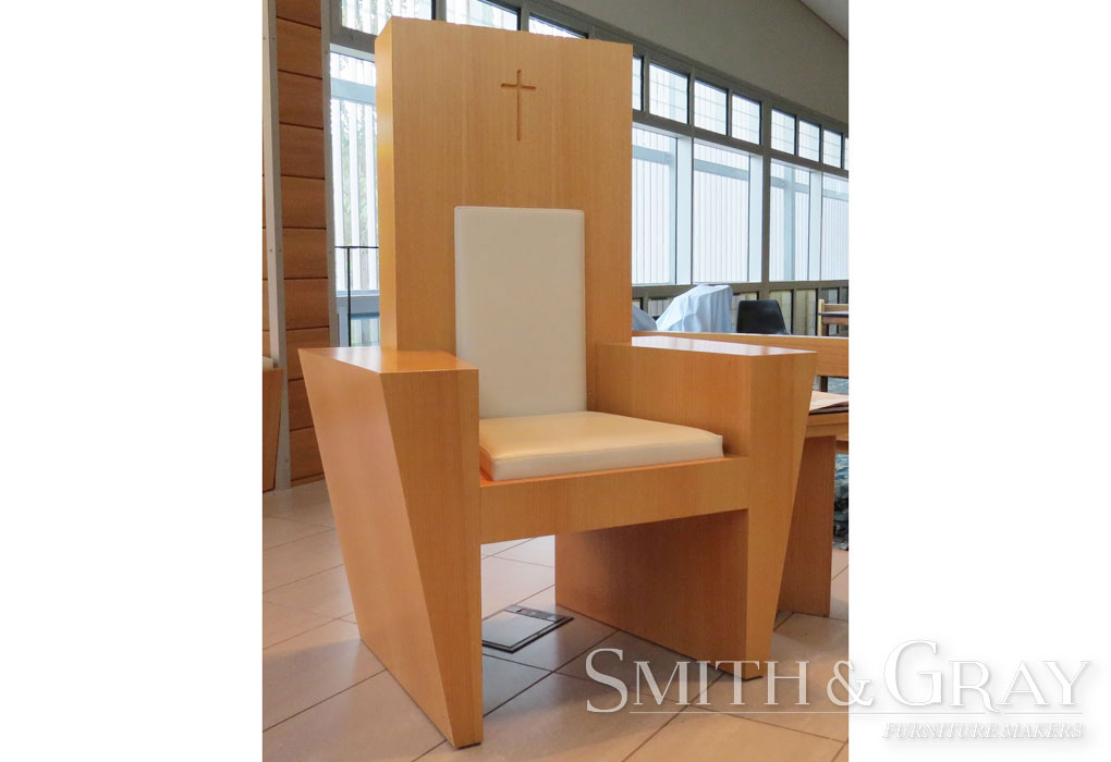 Modern upholstered Tasmanian Oak priests chair with carved crucifix ...